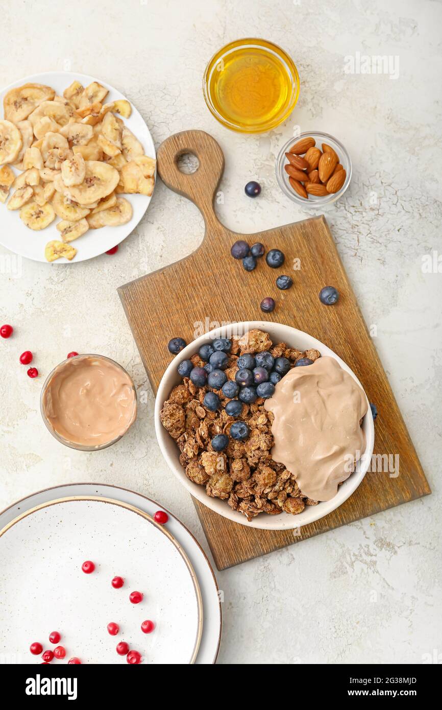 Composition with tasty granola on grunge background Stock Photo - Alamy