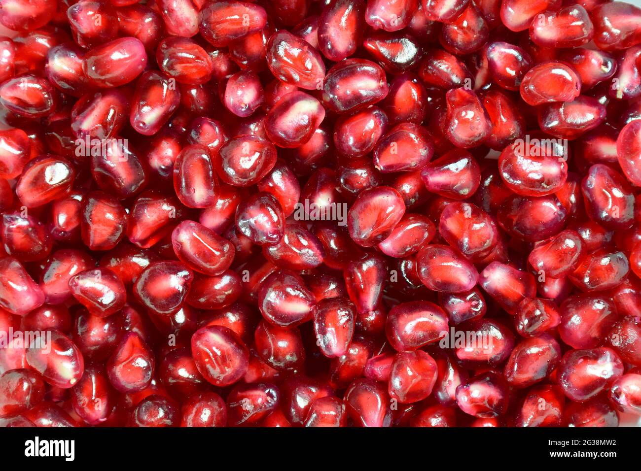 The whole background is covered with juicy bright red pomegranate fruit ...