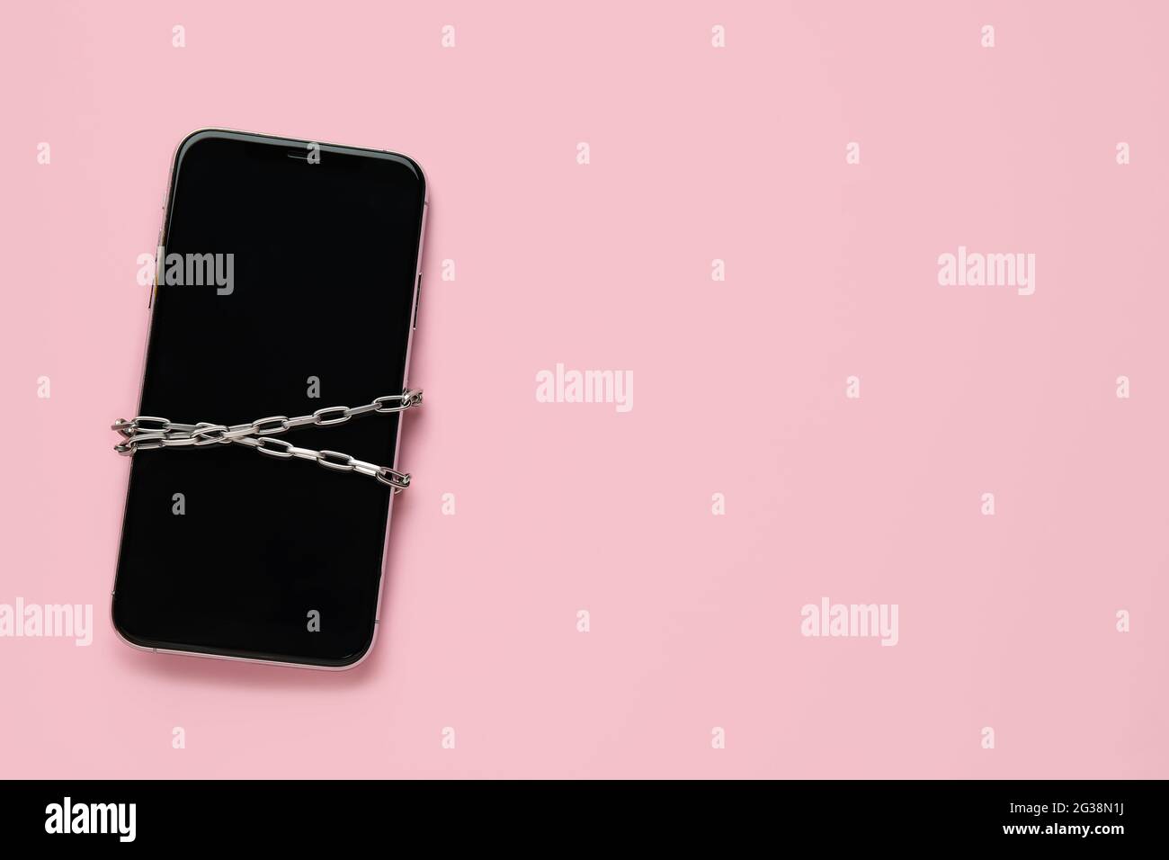 Mobile phone with chain on color background. Concept of addiction to ...