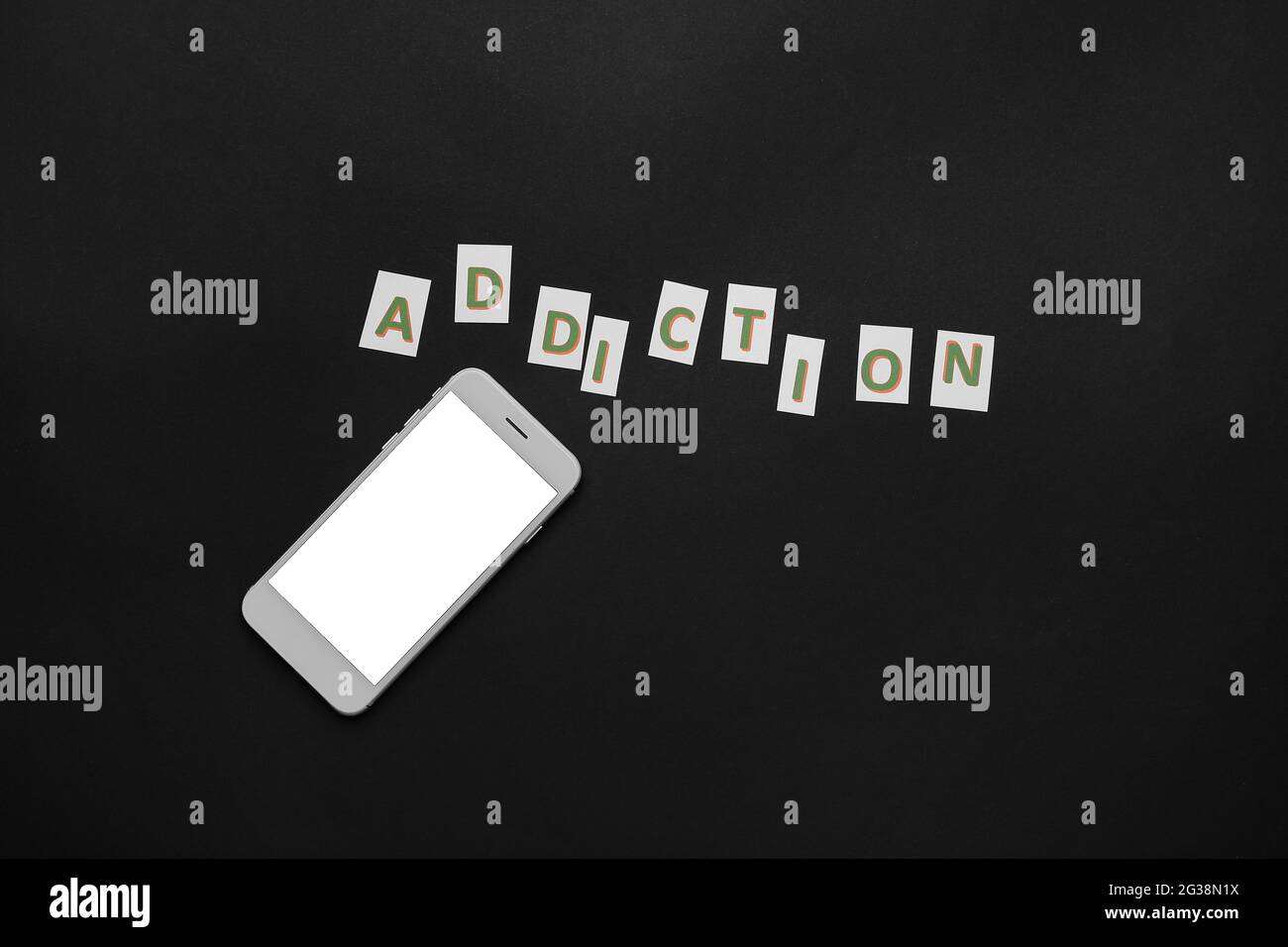 Mobile phone and word ADDICTION on dark background Stock Photo - Alamy