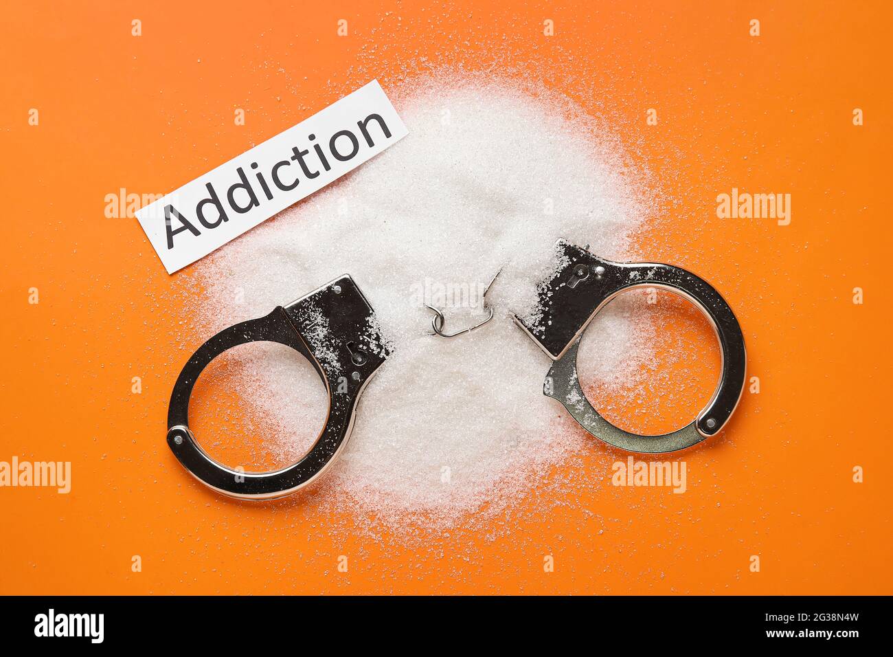 Word ADDICTION, handcuffs and sweet sugar on color background Stock ...