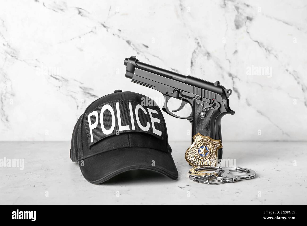 Uniform of policeman with gun and badge on light background Stock Photo ...