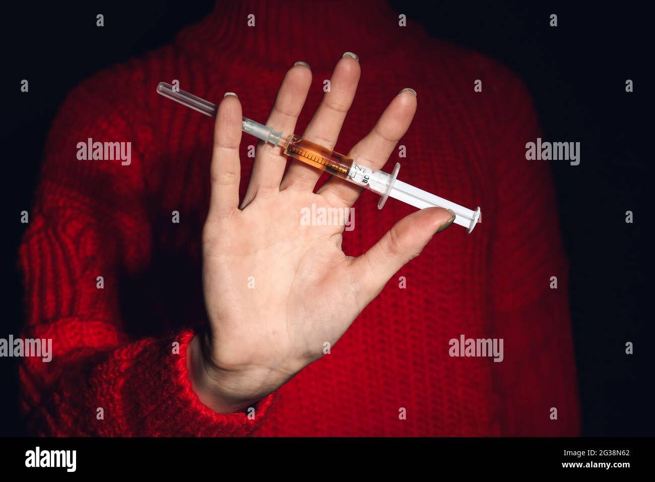 Woman with syringe on dark background. Concept of addiction to drugs ...