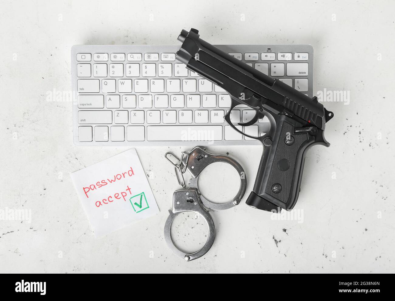 Composition with computer keyboard and gun on white background. Hacking ...
