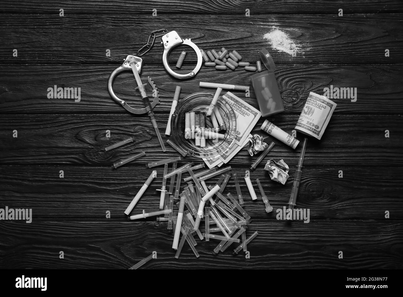 Handcuffs, drugs, money and cigarettes on wooden background. Concept of ...