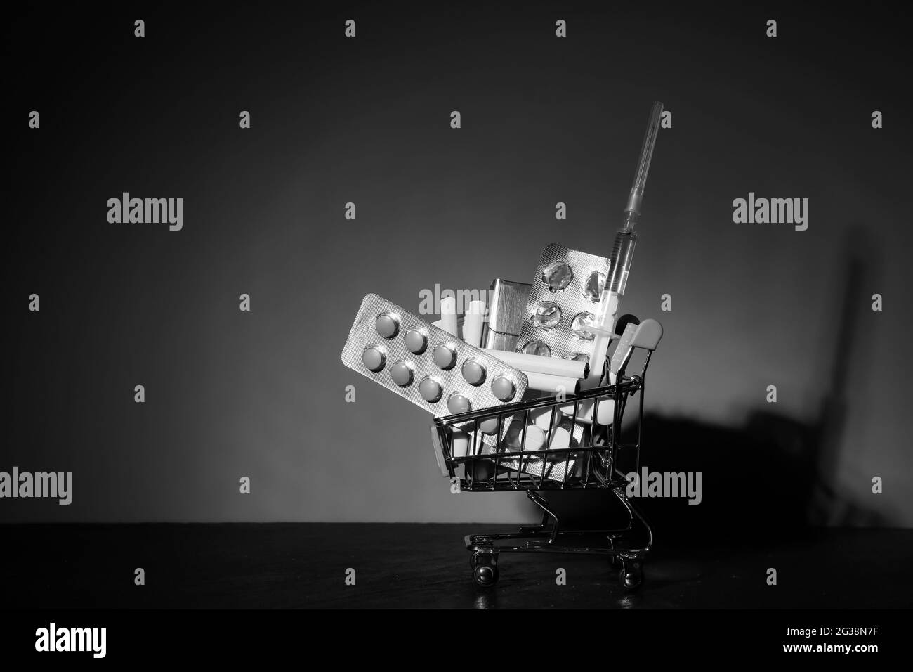 Shopping cart with drugs and cigarettes on dark background. Concept of ...