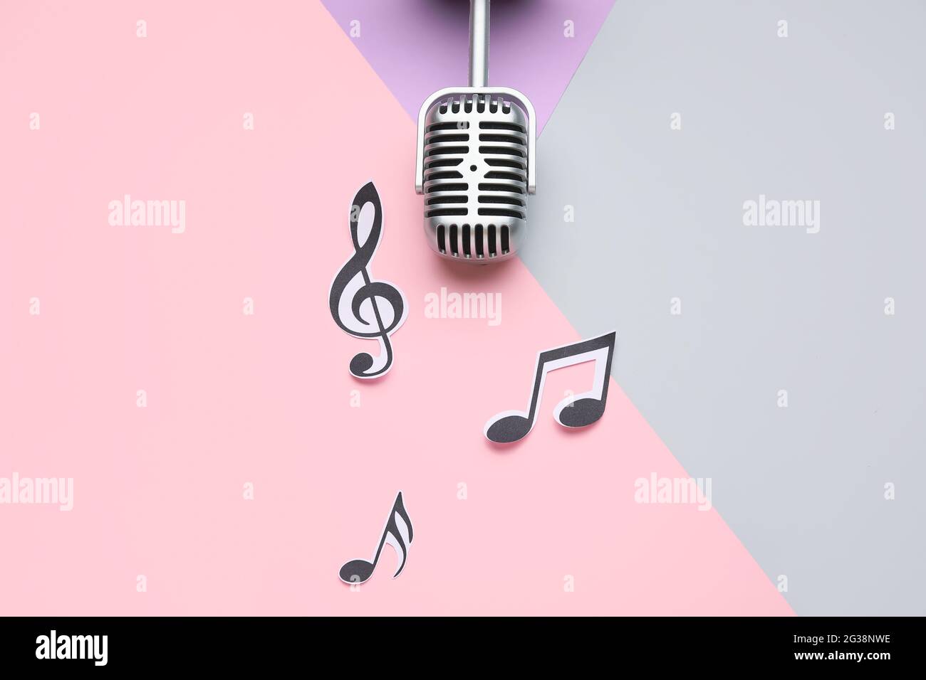 Modern microphone with music notes on color background Stock Photo - Alamy