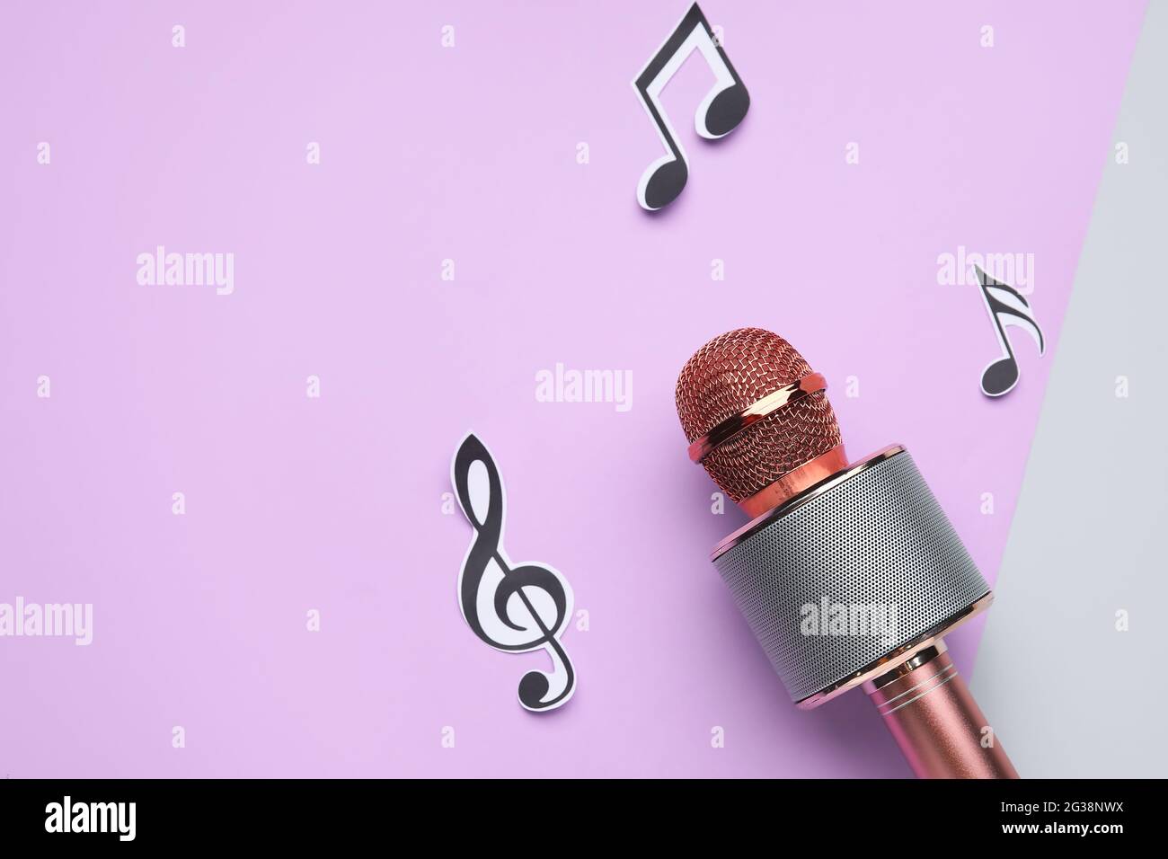Modern microphone with music notes on color background Stock Photo - Alamy