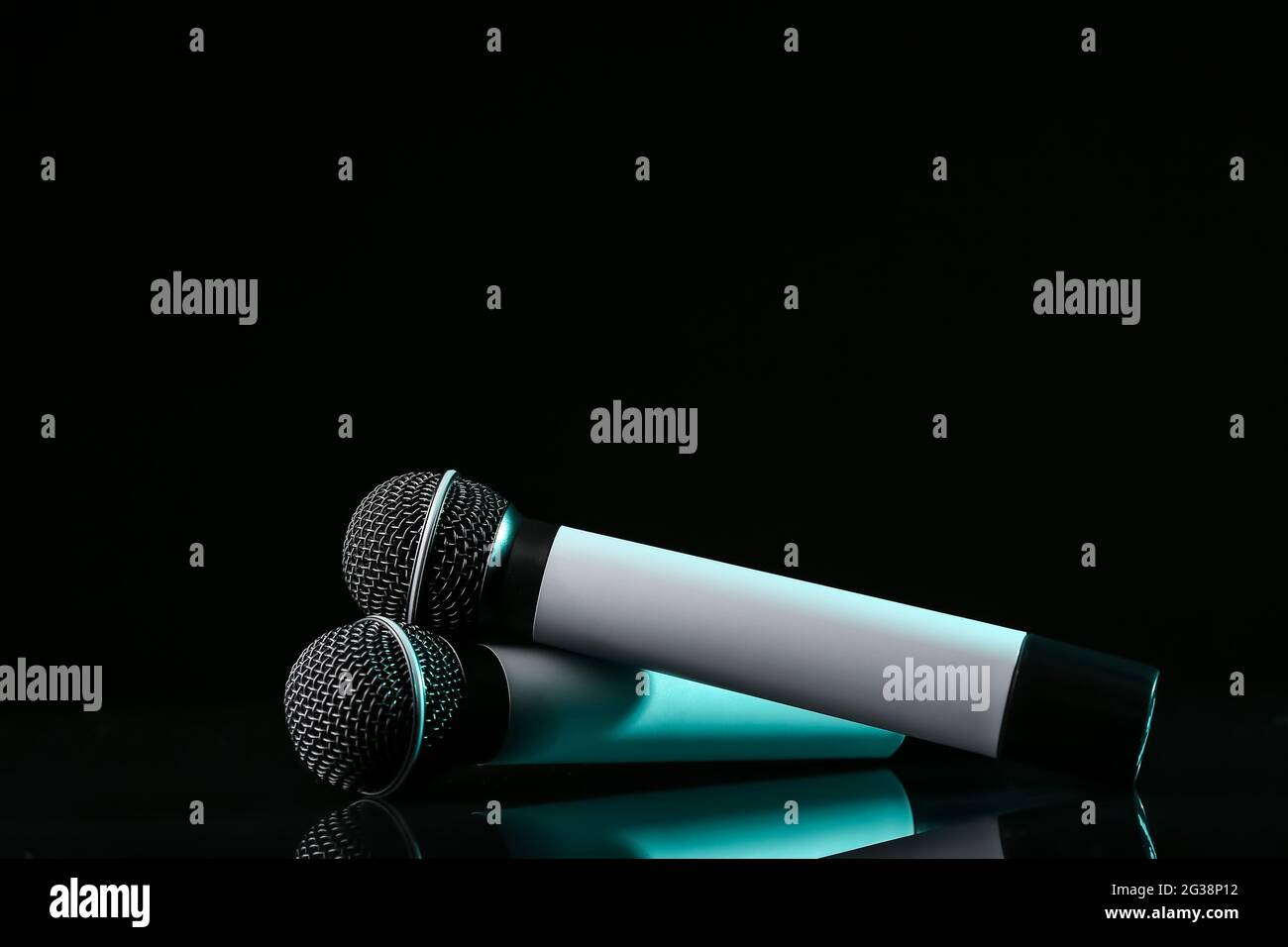 Modern microphones on dark background Stock Photo - Alamy