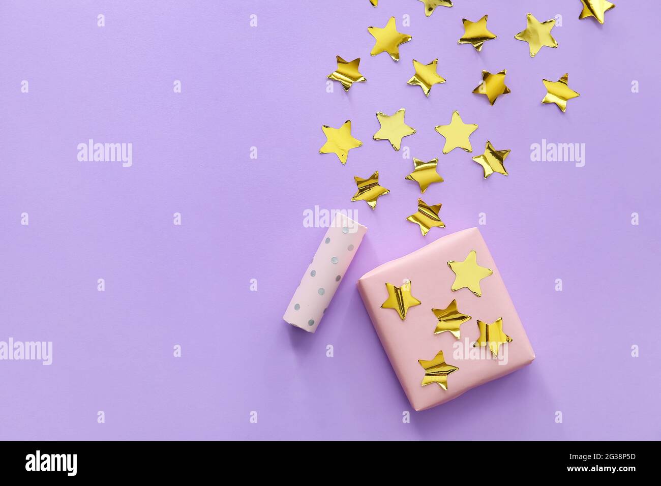 Gift box with party popper and confetti on color background Stock Photo ...