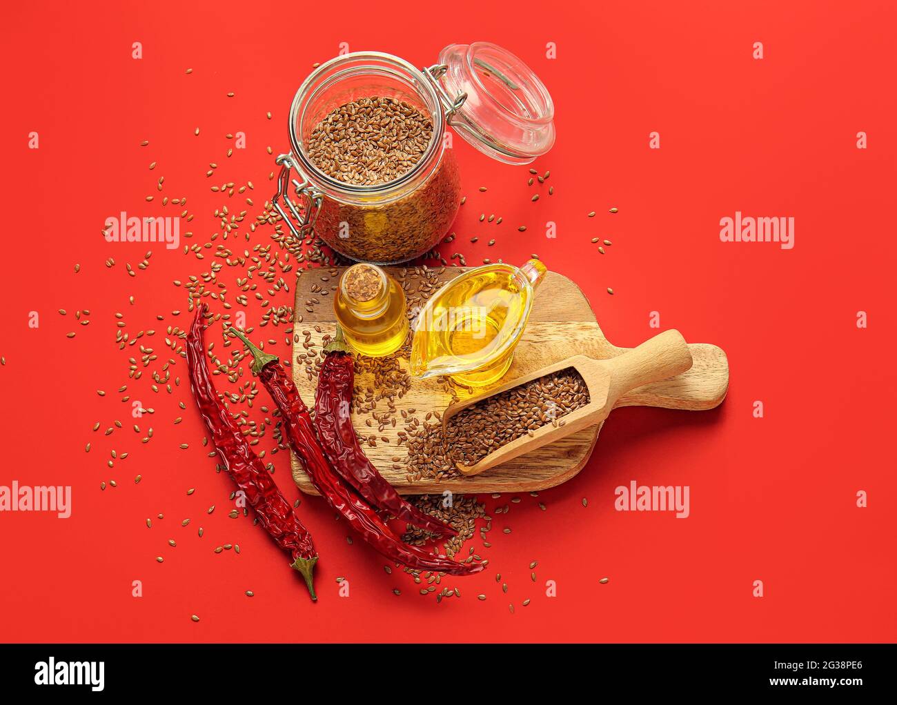 Composition with flax seeds, oil and chili peppers on color background ...