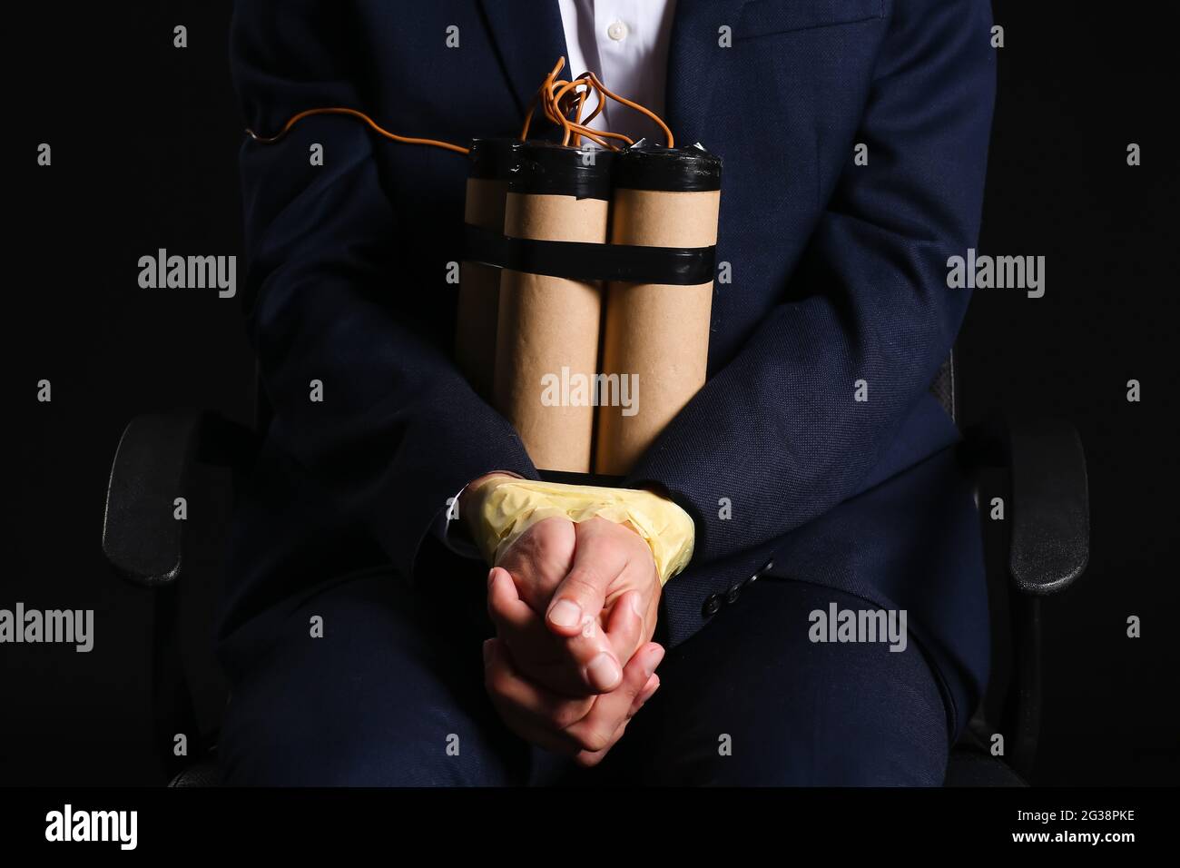 Male hostage with bomb on dark background Stock Photo - Alamy