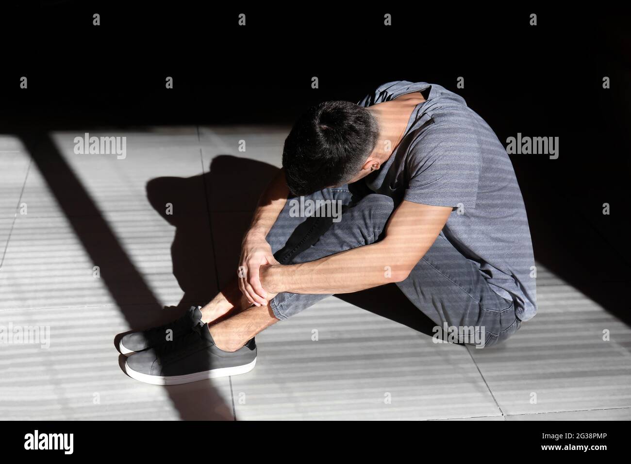 Male hostage sitting on floor in room Stock Photo - Alamy