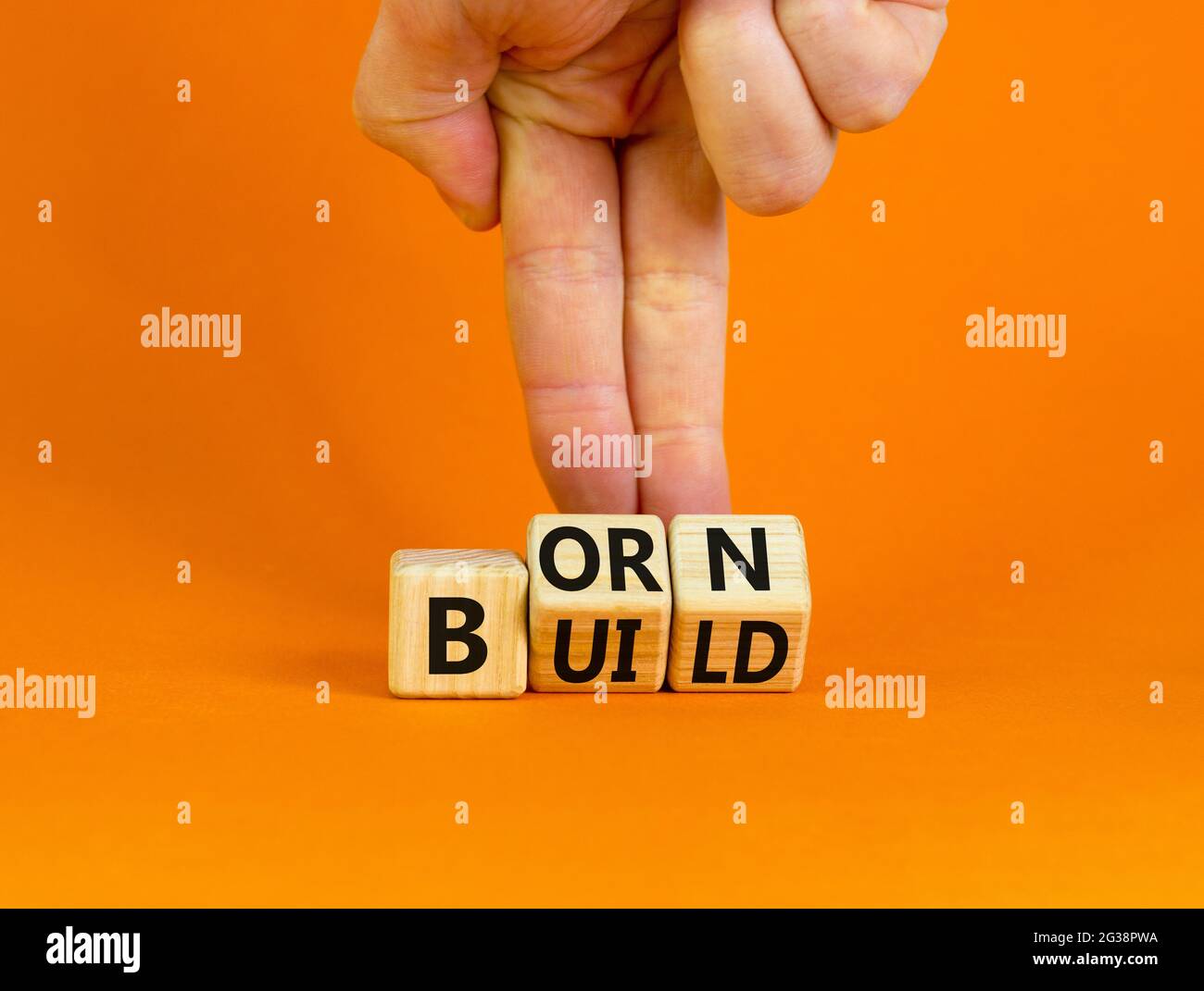 Born or build symbol. Businessman turns wooden cubes and changes the ...