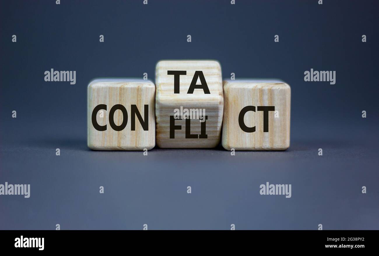 Conflict or contact symbol. Turned the wooden cube and changed the word ...