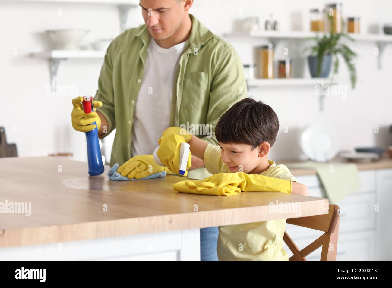 Father and son cleaning table in kitchen Stock Photo - Alamy