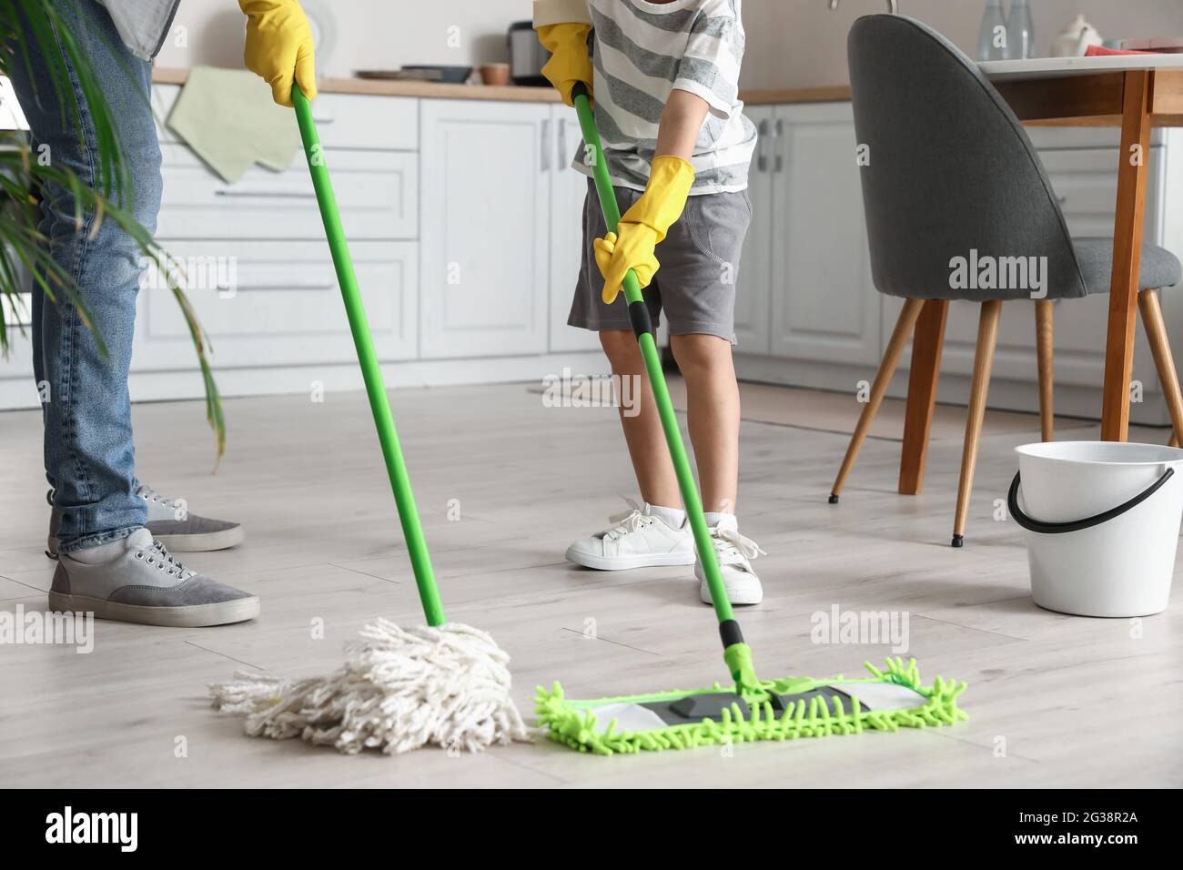 Father and son mopping floor in kitchen Stock Photo - Alamy