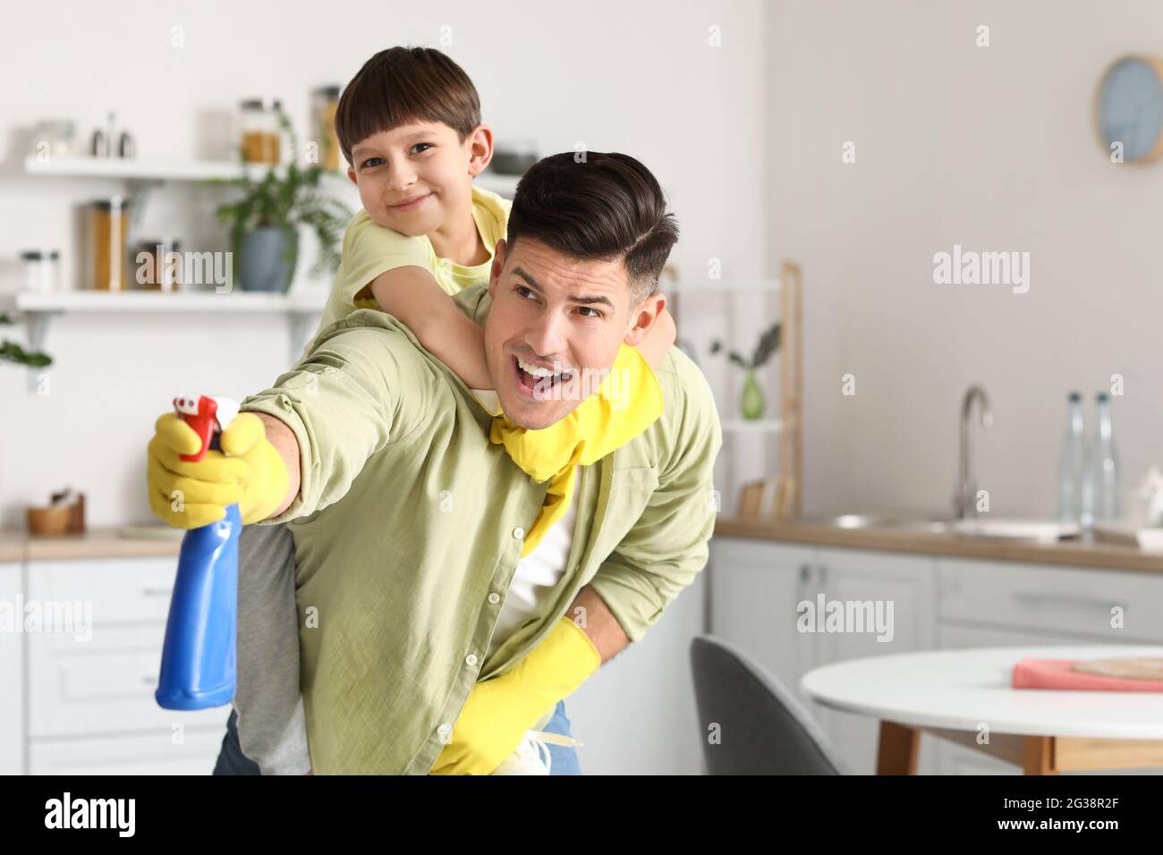 Father and son having fun while cleaning kitchen Stock Photo - Alamy