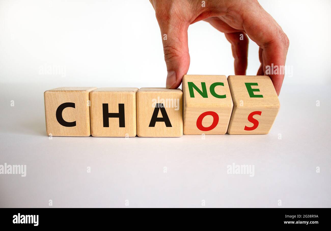 Chance or chaos symbol. Businessman turns wooden cubes and changes the ...