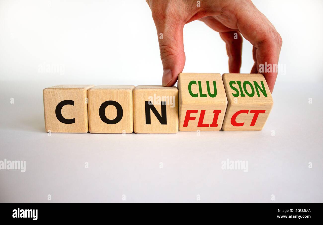 Conflict or conclusion symbol. Businessman turns wooden cubes and ...