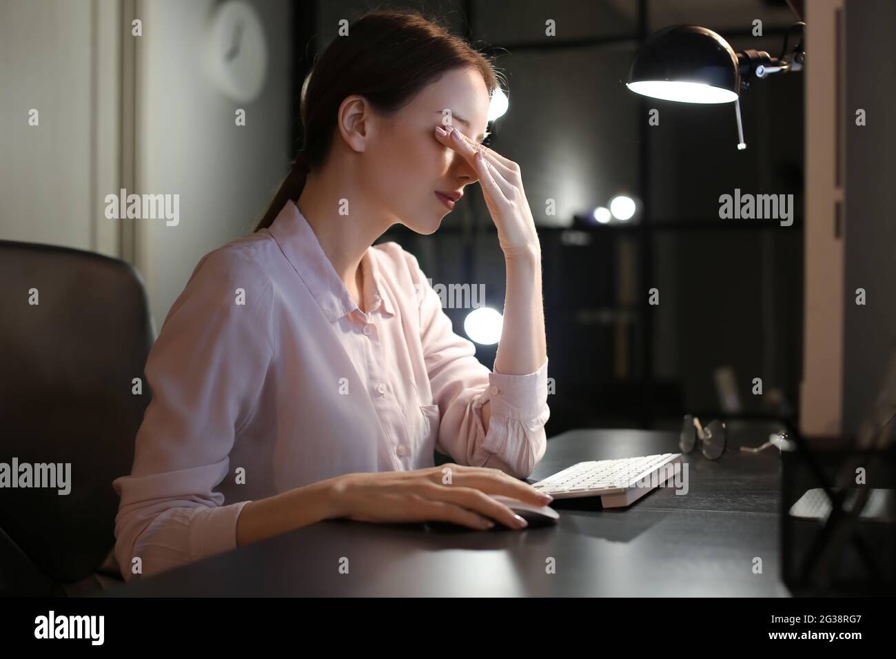Tired beautiful woman working at home late in evening Stock Photo - Alamy