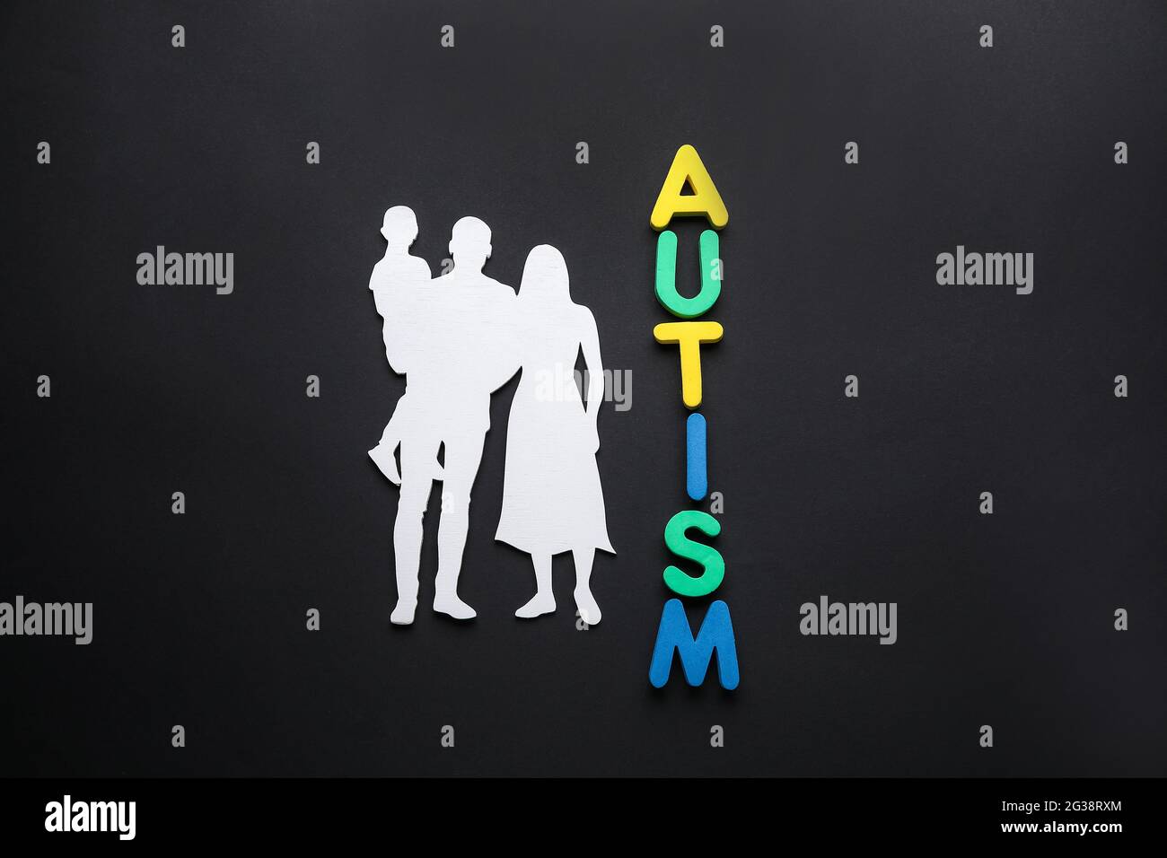 Family figure and Word AUTISM on dark background Stock Photo - Alamy