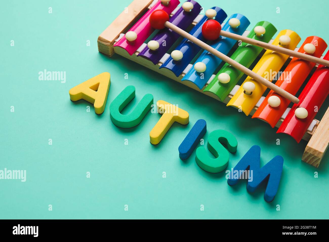 Word AUTISM and xylophone on color background Stock Photo - Alamy