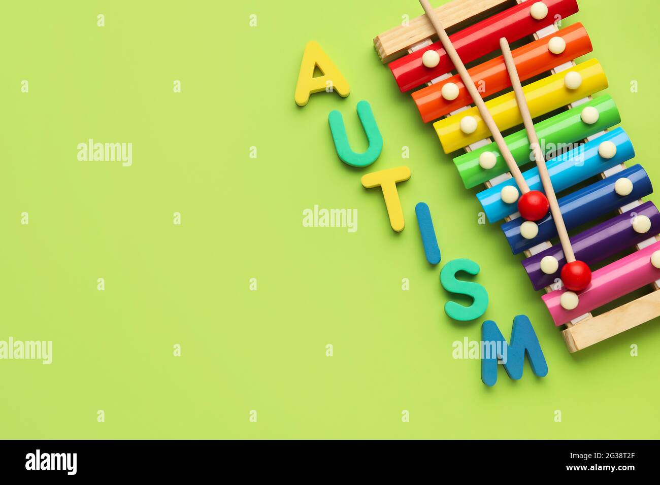 Word AUTISM and xylophone on color background Stock Photo - Alamy