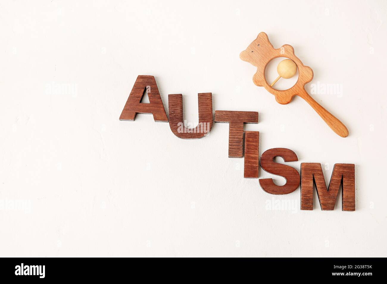 Word AUTISM and rattle on white background Stock Photo - Alamy