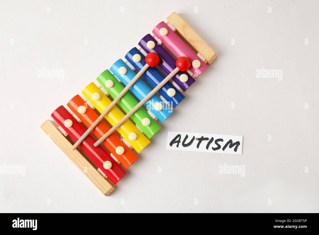 Word AUTISM and xylophone on light background Stock Photo - Alamy