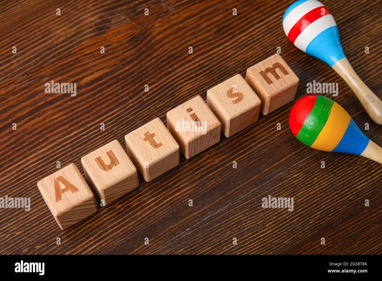Word AUTISM and maracas on dark wooden background Stock Photo - Alamy