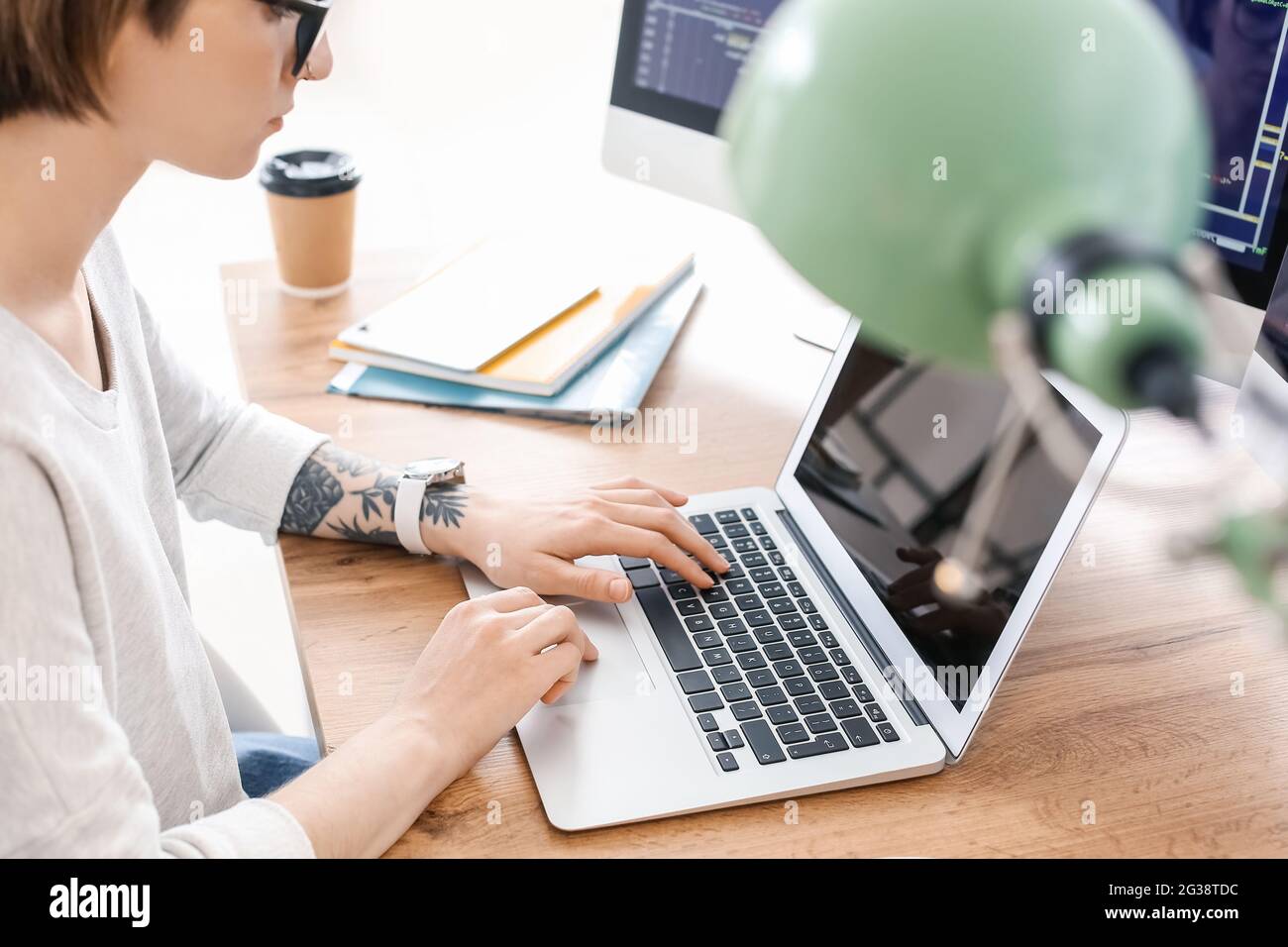 Female programmer working with laptop in office Stock Photo - Alamy