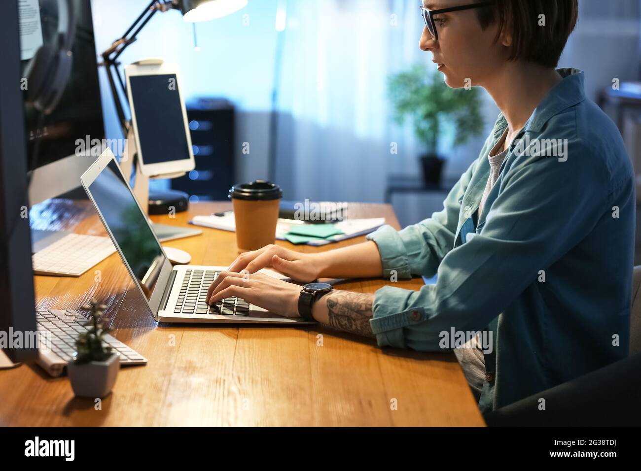 Female programmer working in office at night Stock Photo - Alamy
