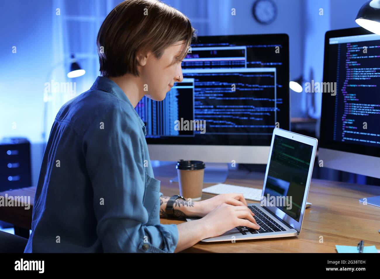 Female programmer working in office at night Stock Photo - Alamy