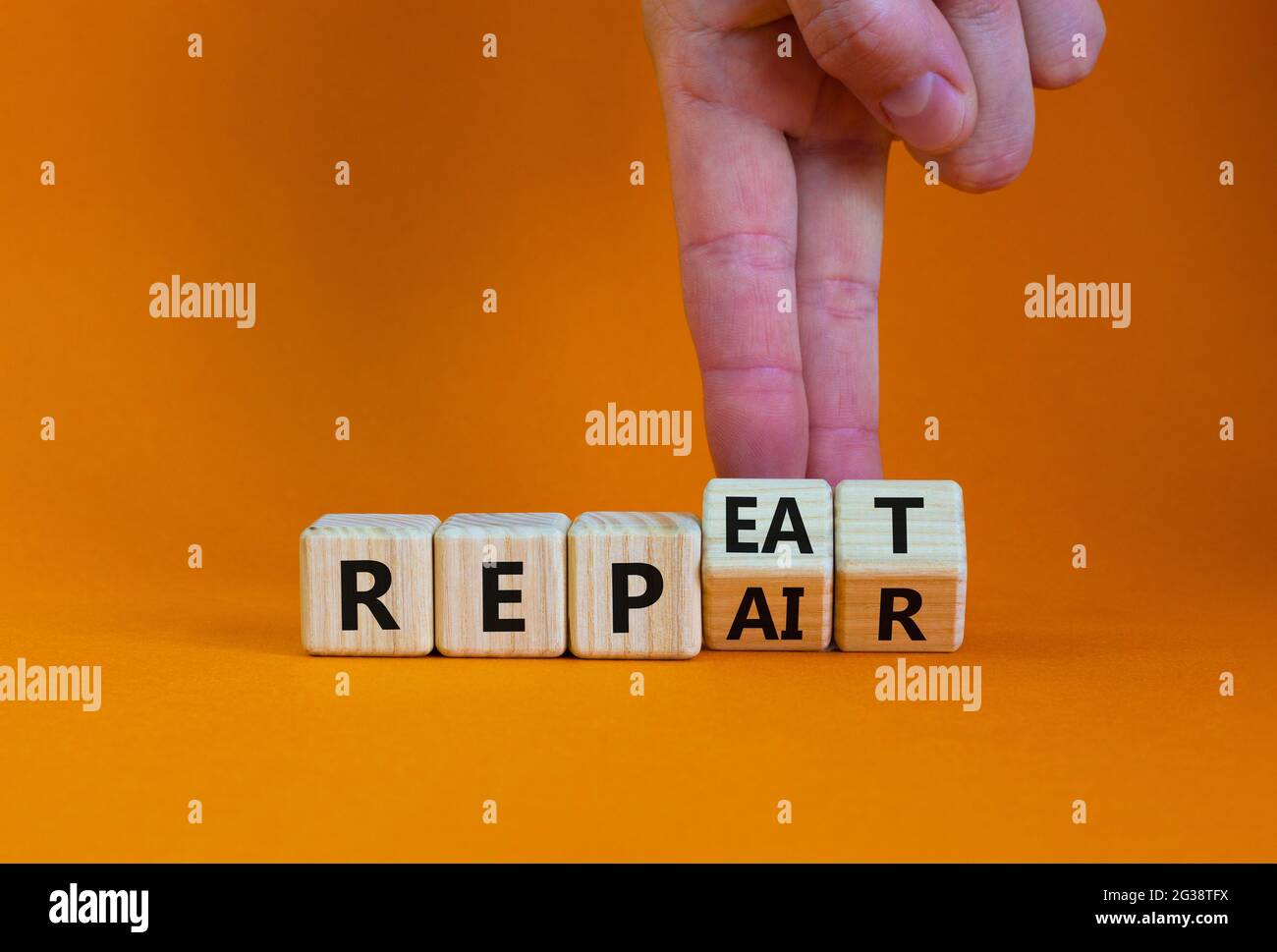 Repeat and repair symbol. Businessman turns wooden cubes and changes ...