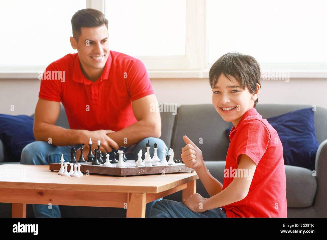 Father and son playing chess at home Stock Photo - Alamy