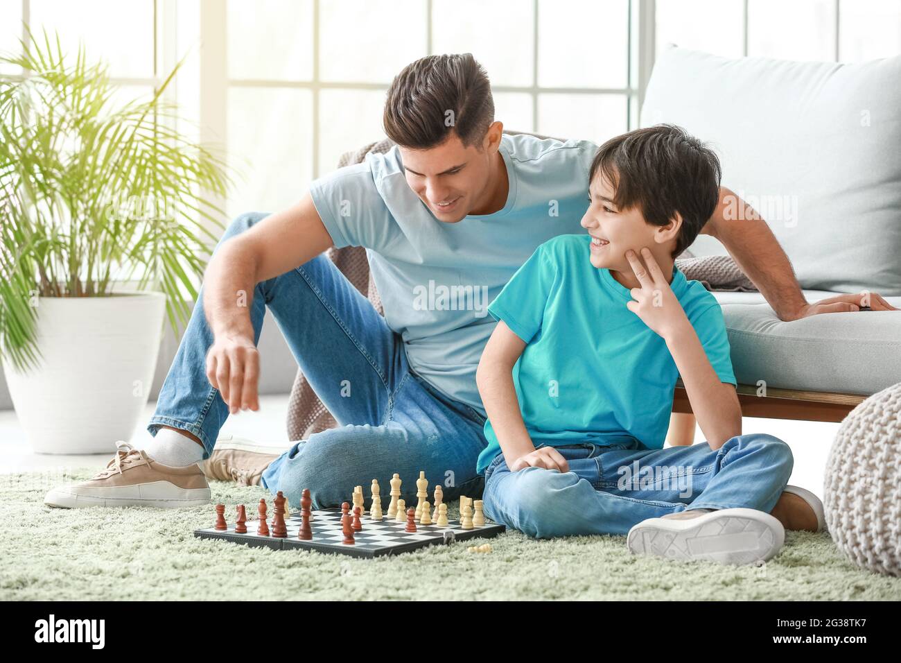 Father and son playing chess at home Stock Photo - Alamy