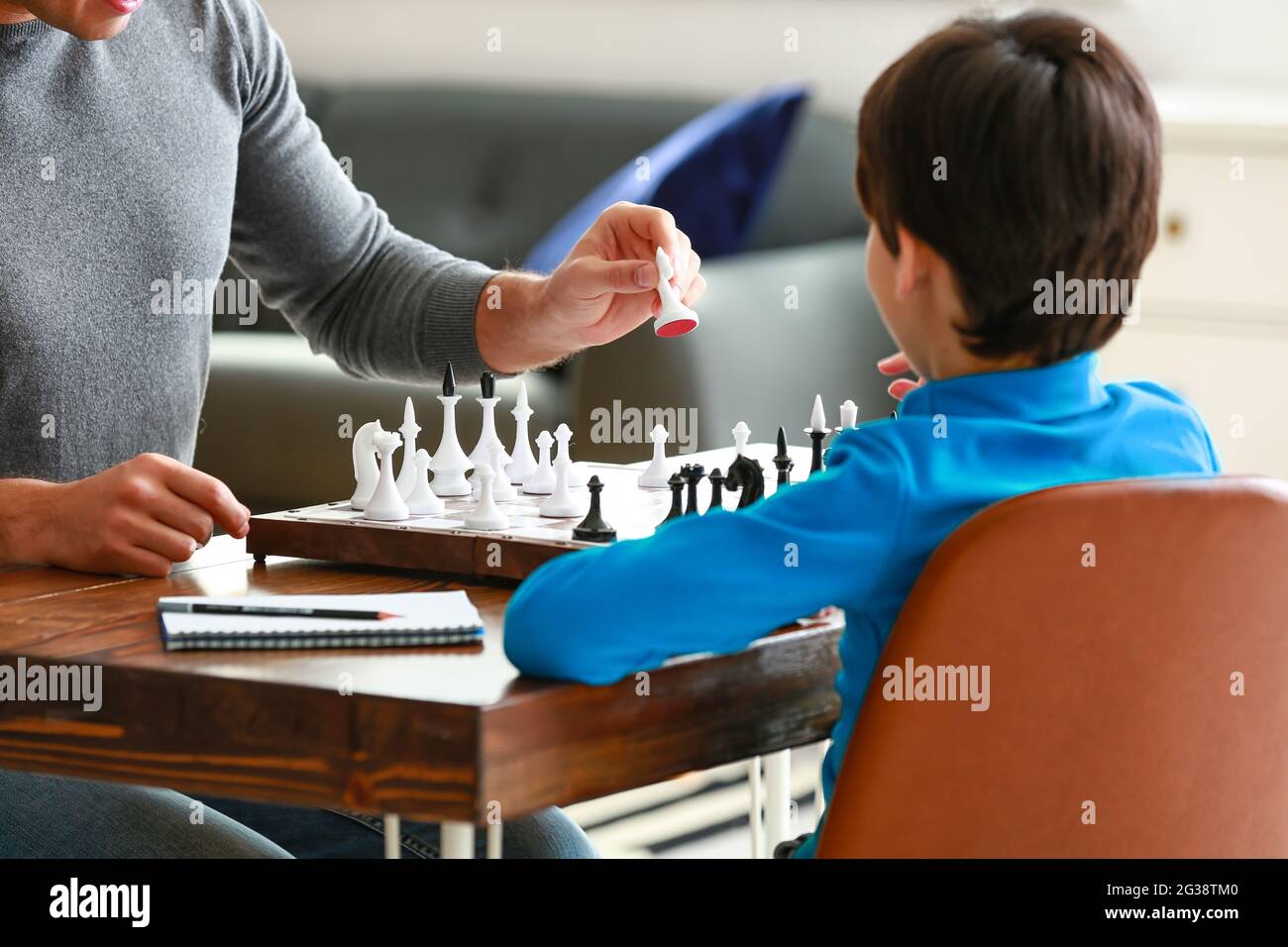 Father and son playing chess at home Stock Photo - Alamy