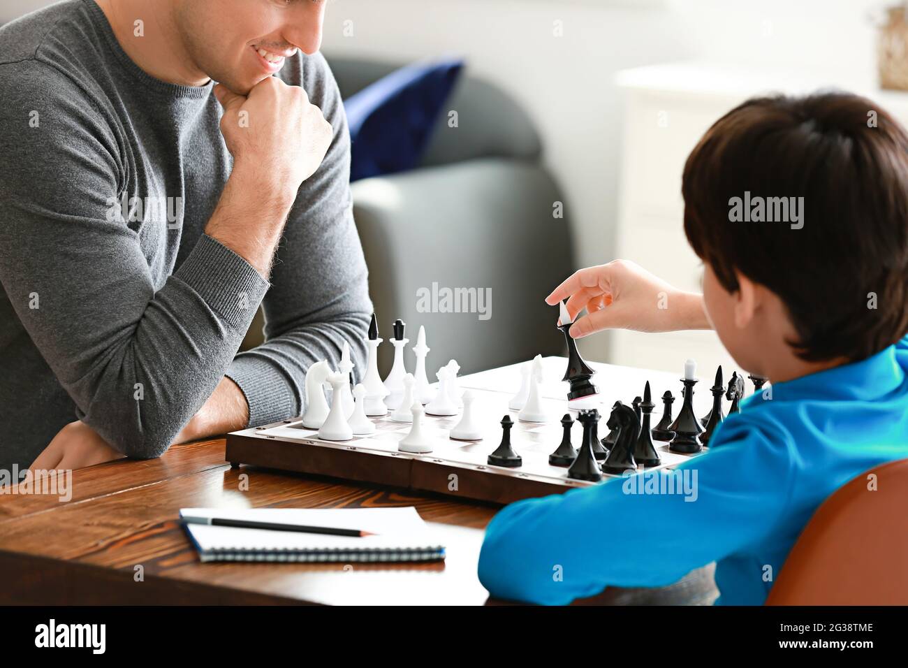 Father and son playing chess at home Stock Photo - Alamy