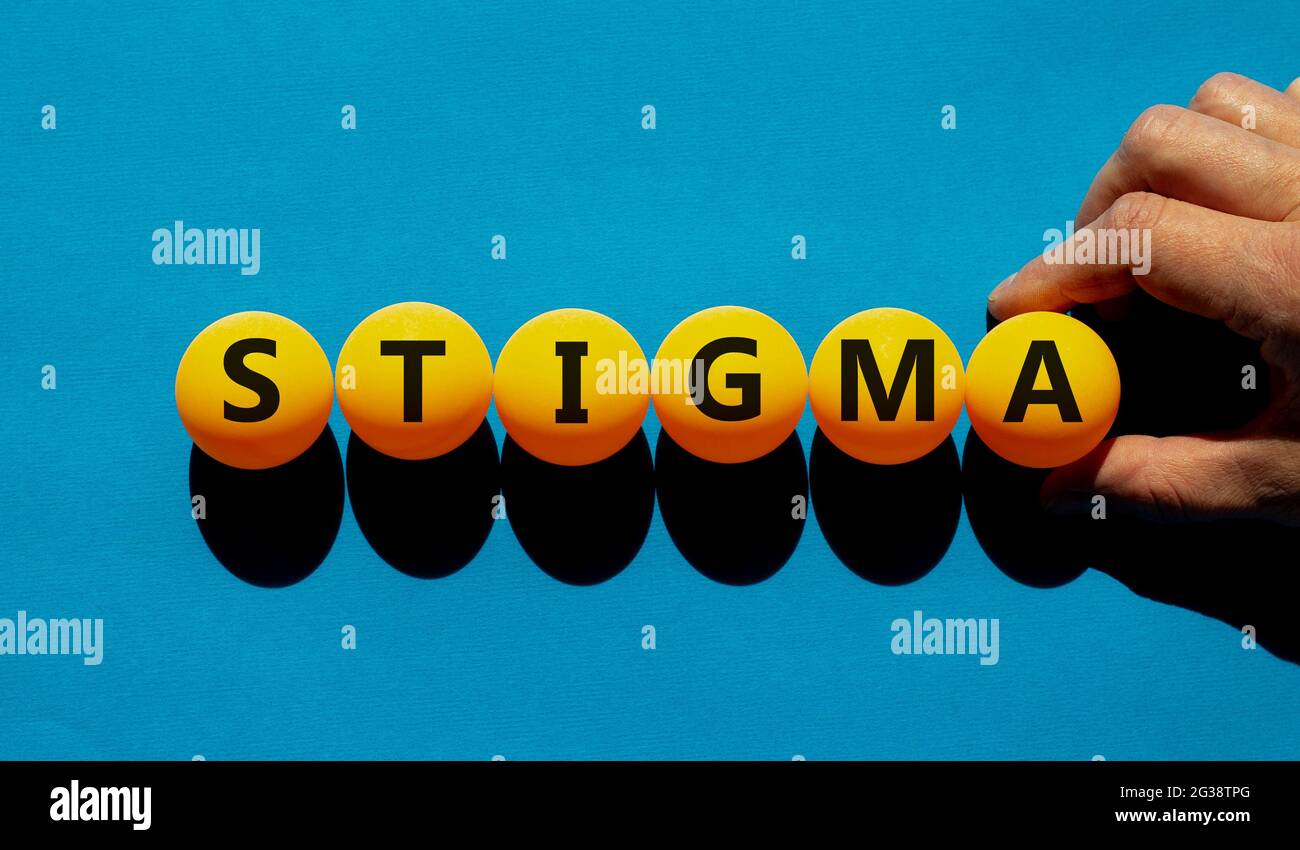 Medical and stigma symbol. The concept word 'stigma' on orange table ...