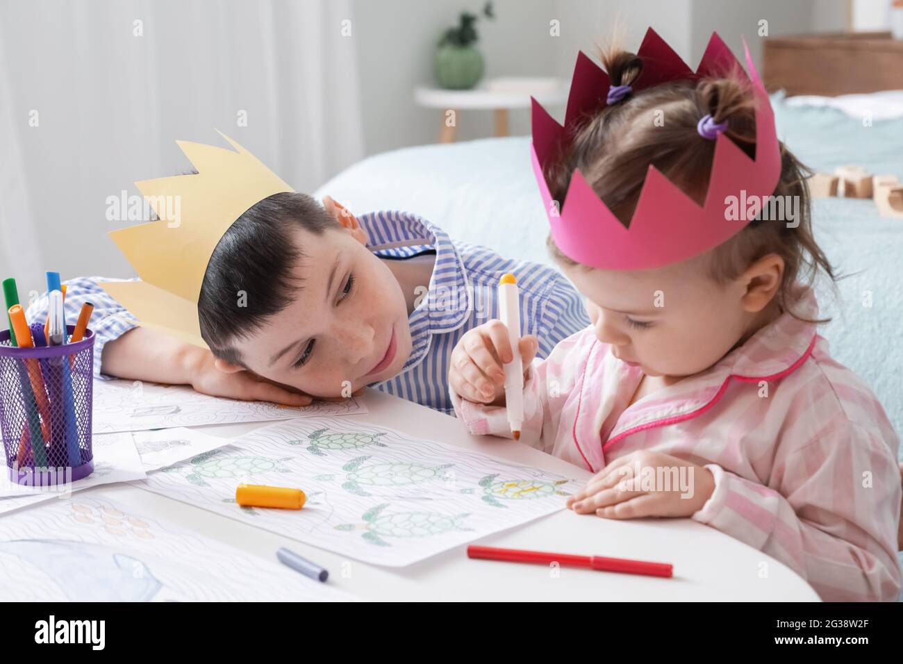 Cute little children drawing in bedroom Stock Photo - Alamy