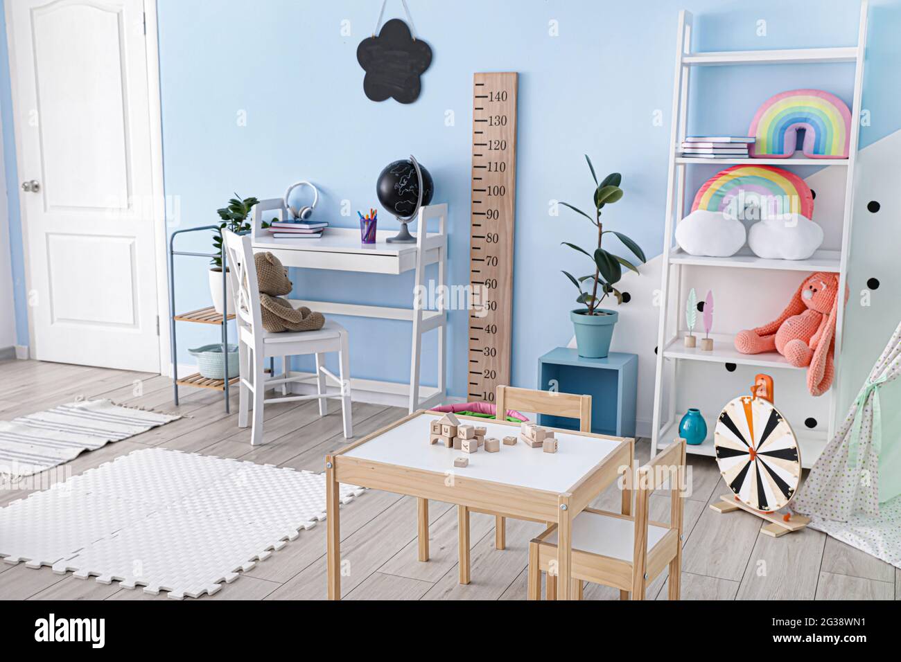 Stylish interior of modern children's room with wooden stadiometer ...