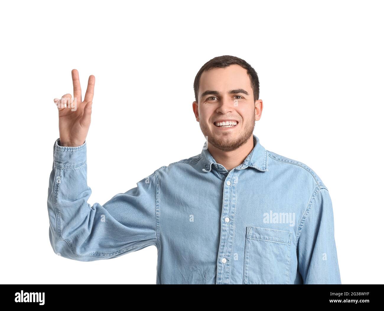 Handsome man showing victory gesture on white background Stock Photo ...