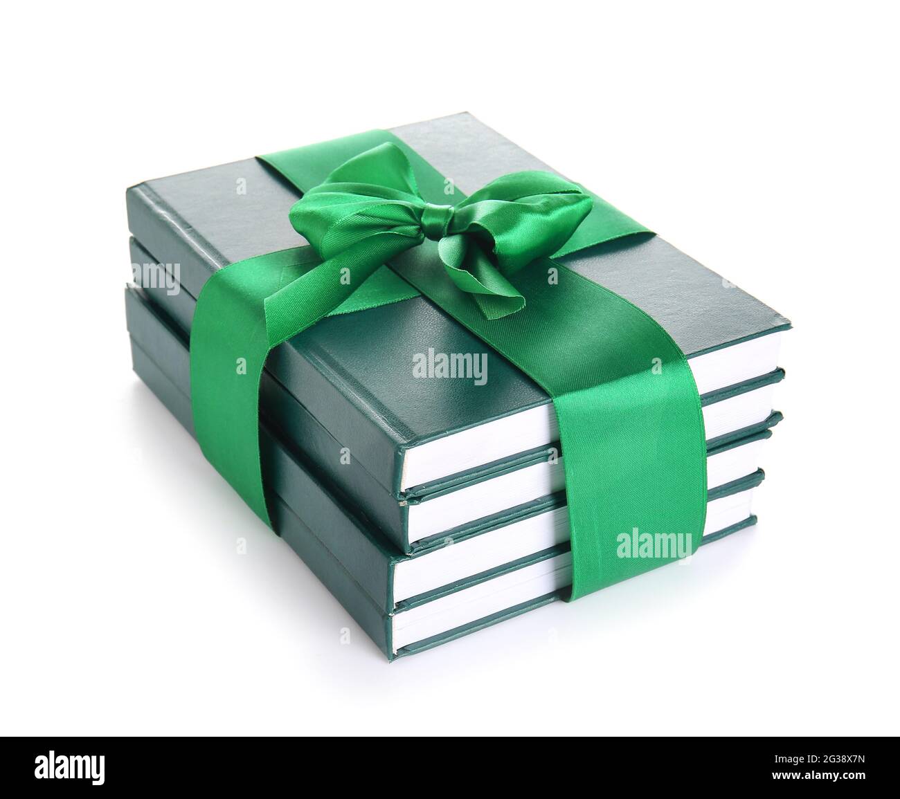 Stack of books with green ribbon on white background Stock Photo - Alamy