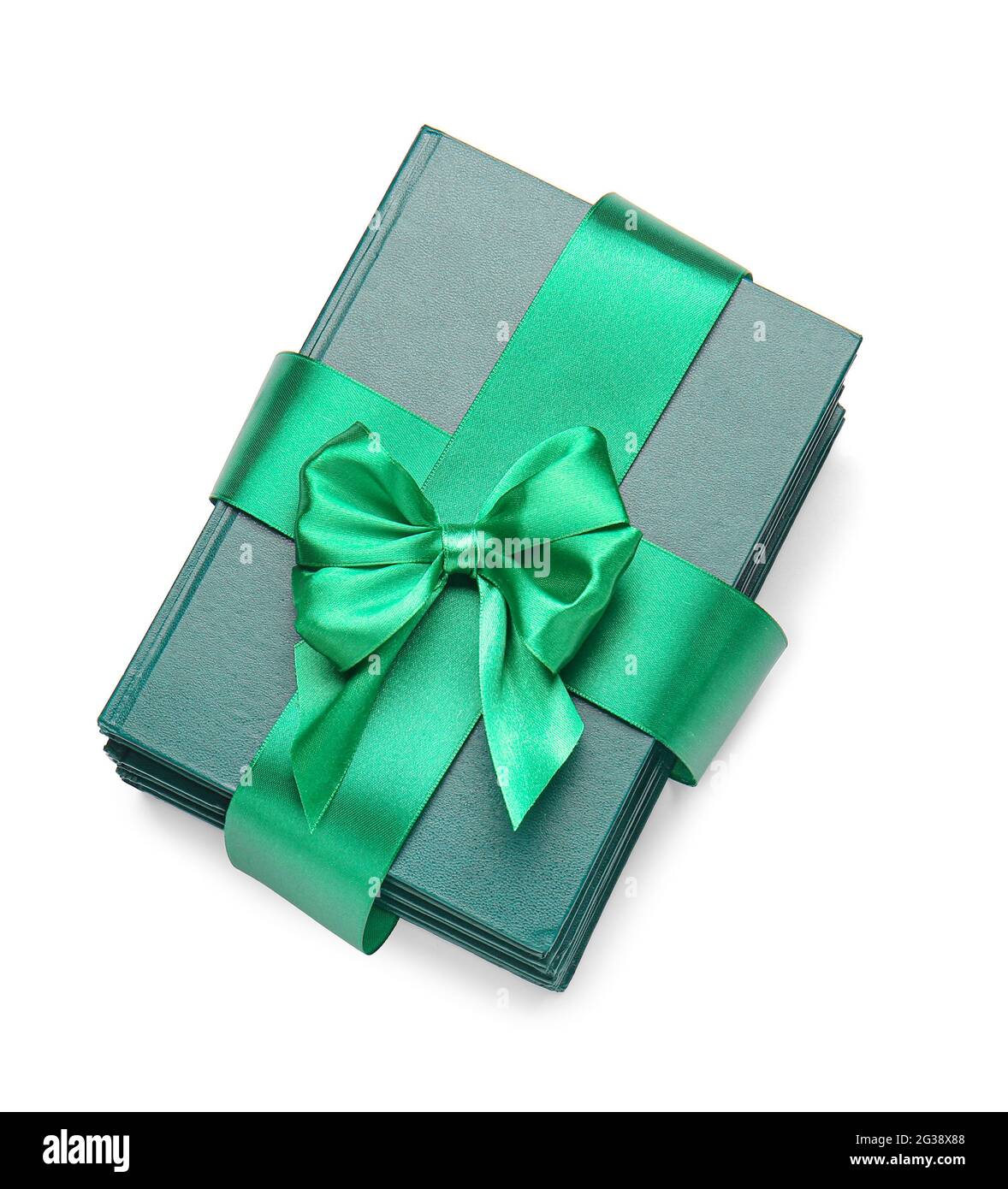 Stack of books with green ribbon on white background Stock Photo - Alamy