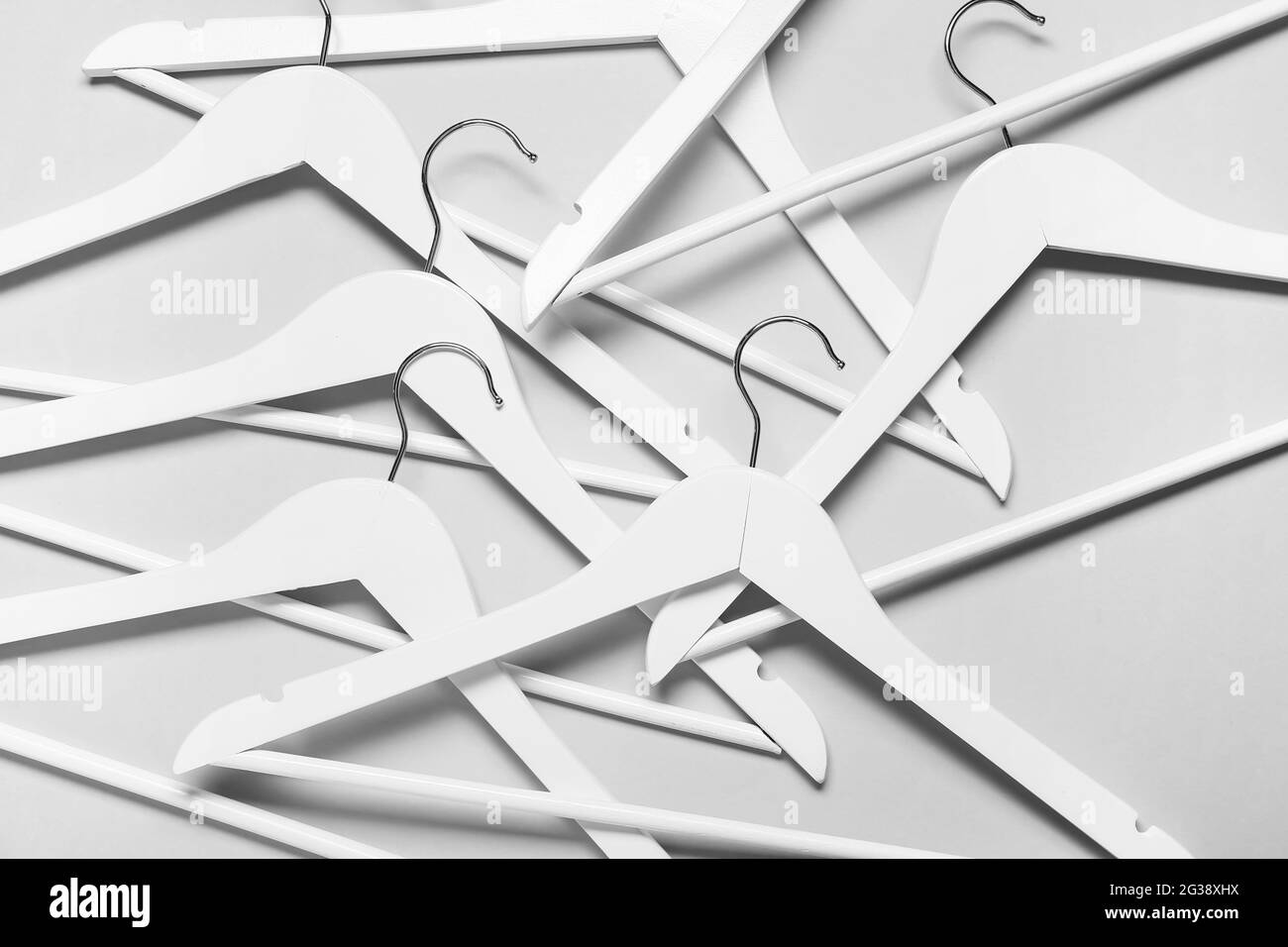 Stylish clothes hangers on light background Stock Photo - Alamy