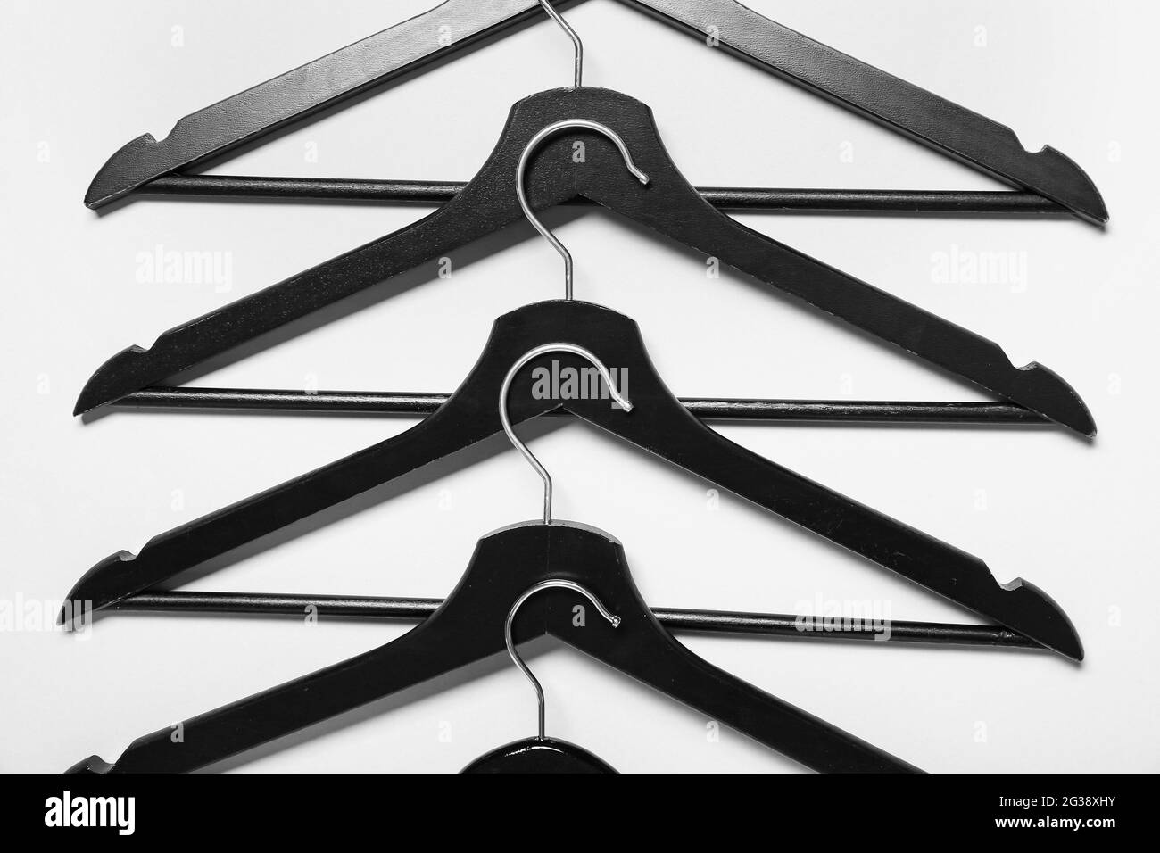 Stylish clothes hangers on light background Stock Photo - Alamy