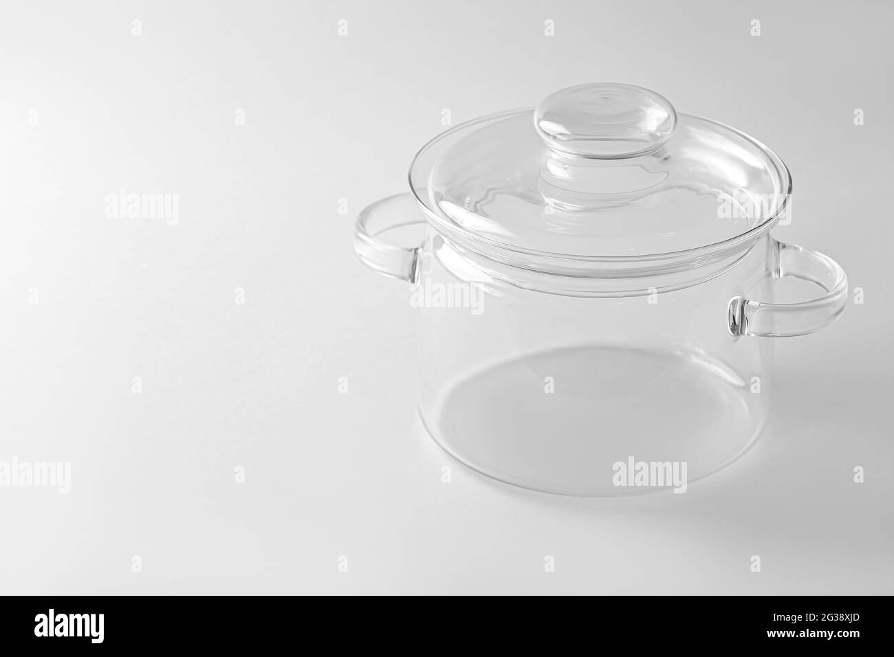 Stylish cooking pot on light background Stock Photo - Alamy