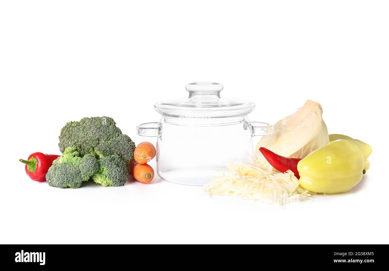 Stylish cooking pot and vegetables on white background Stock Photo - Alamy