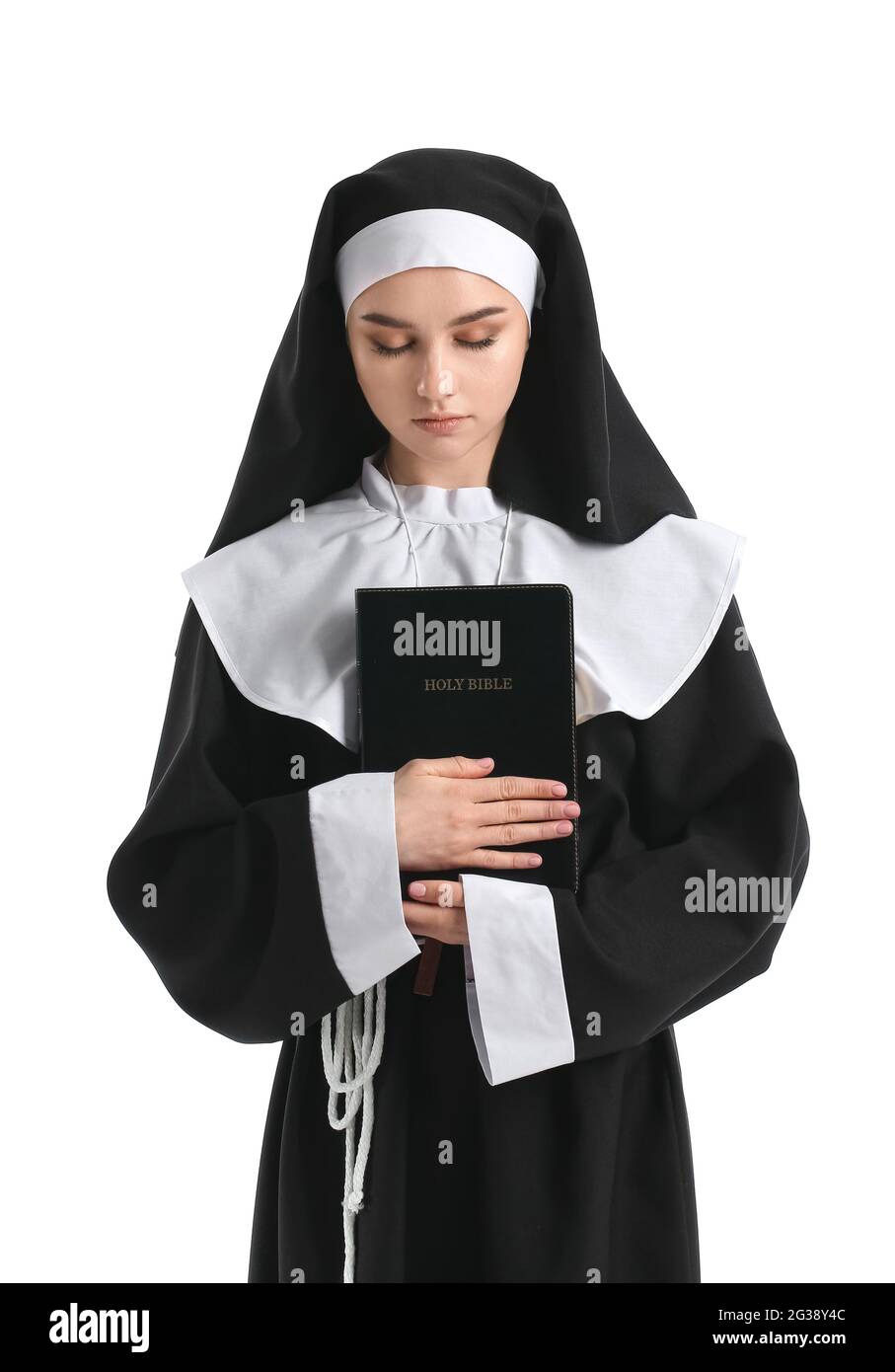 Young praying nun with Bible on white background Stock Photo - Alamy